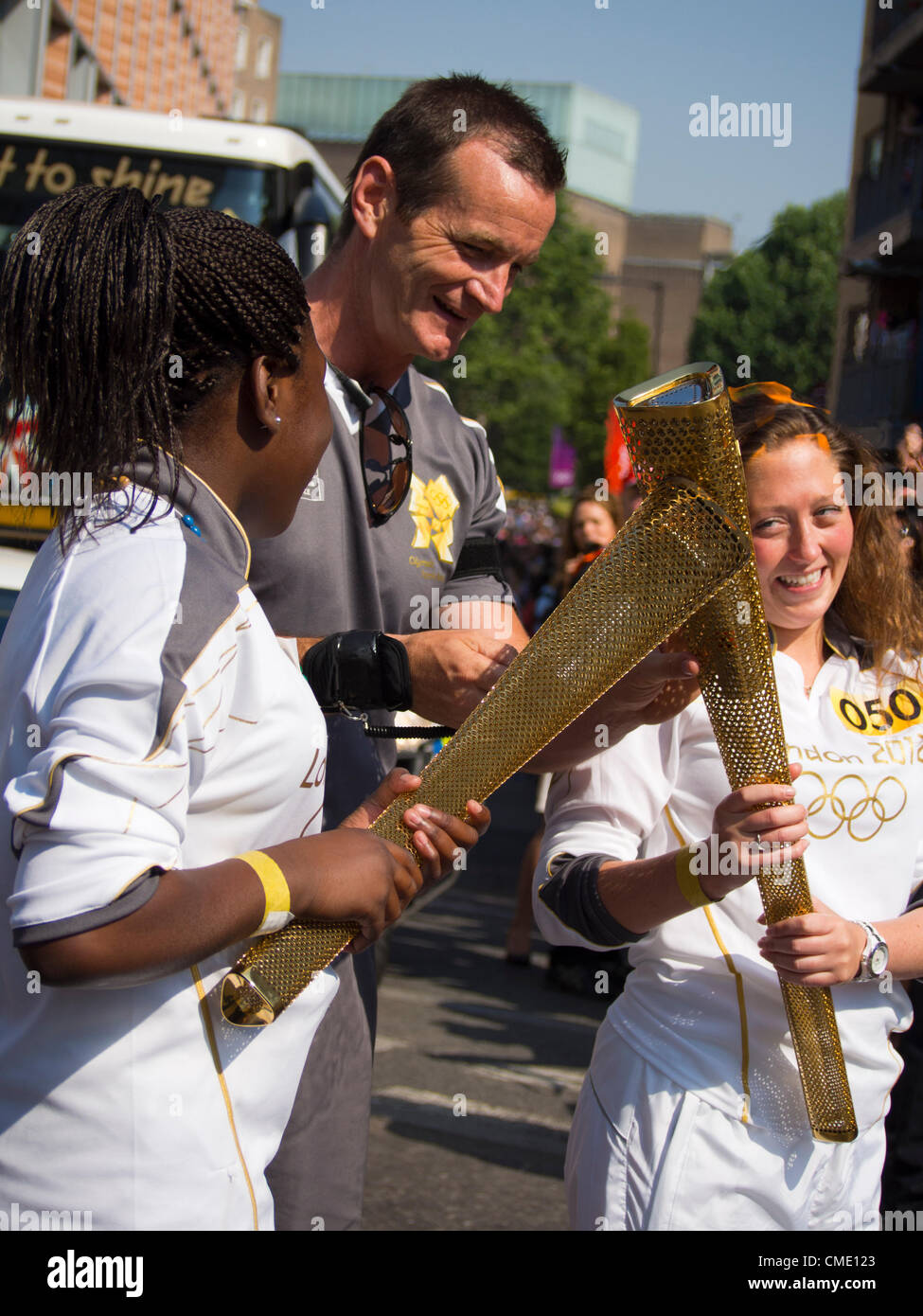 London, UK. 26 July, 2012. Passing the Olympic torch in Southwark 2 ...