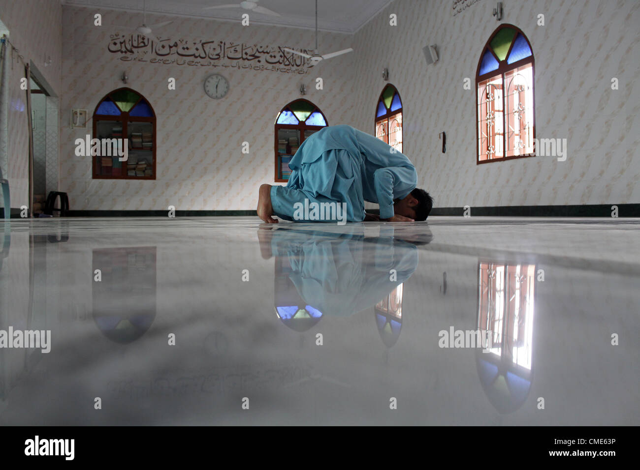 A Pakistani Muslim boy offers prayer at a mosque during holy month of ...