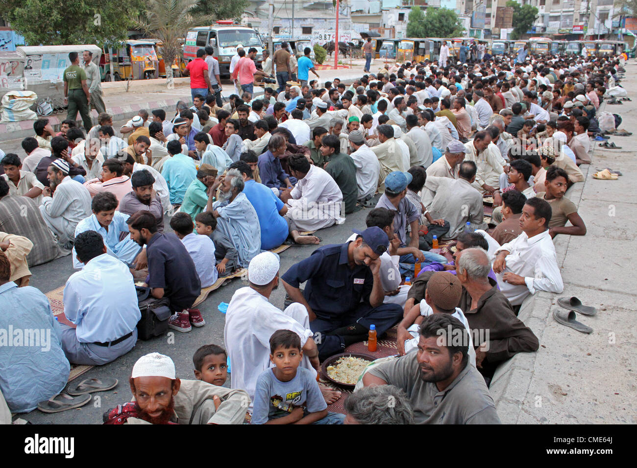 Pakistani Muslims wait for aftari (food for breakfast) on a road during ...