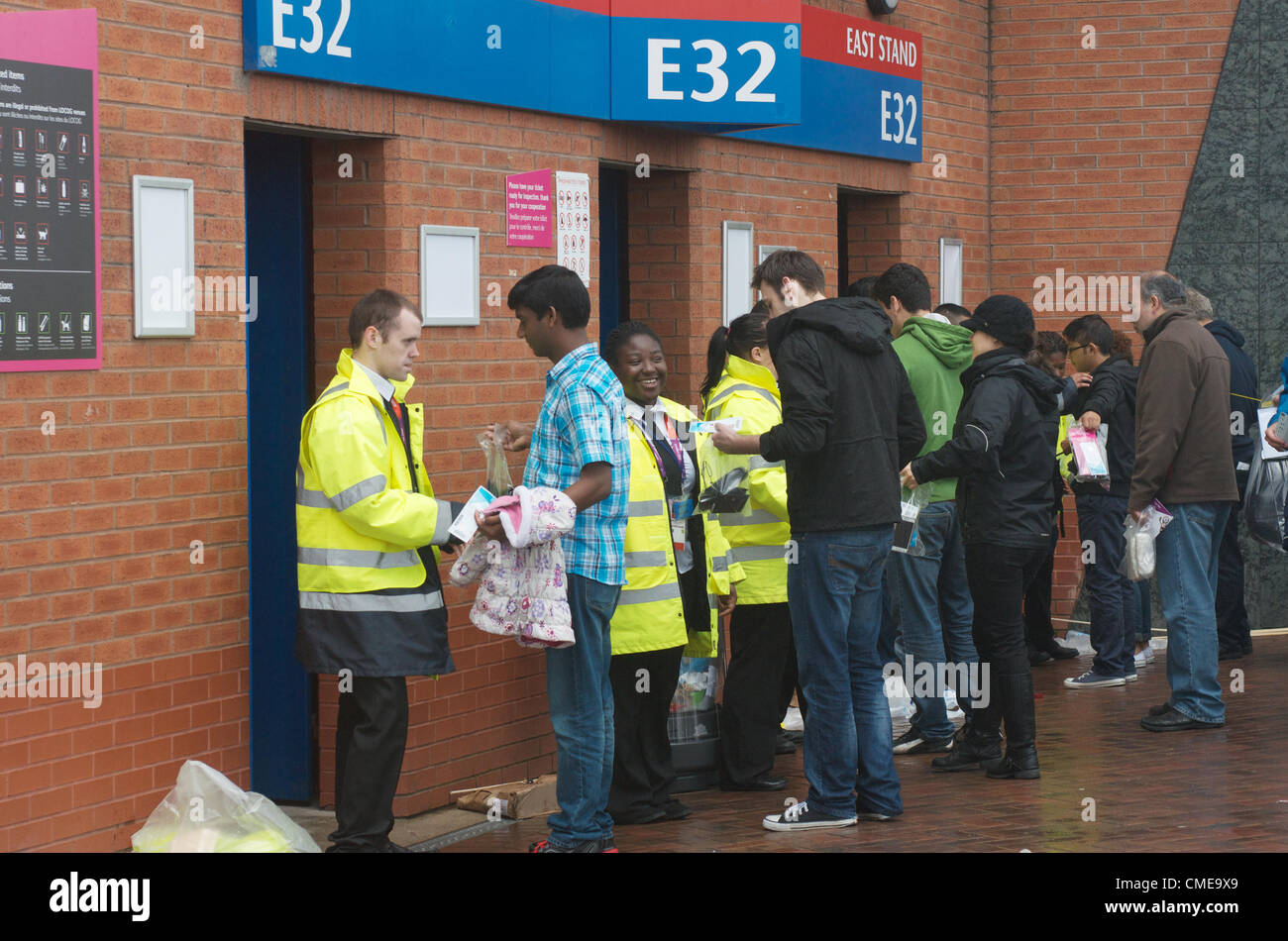 A security guard examines items being brought into Old Trafford ...