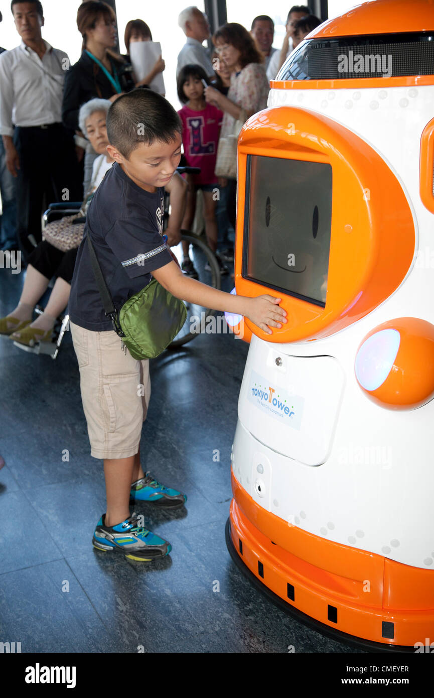 August 01 2012, Tokyo, Japan - A kid touches the new robot guide ...