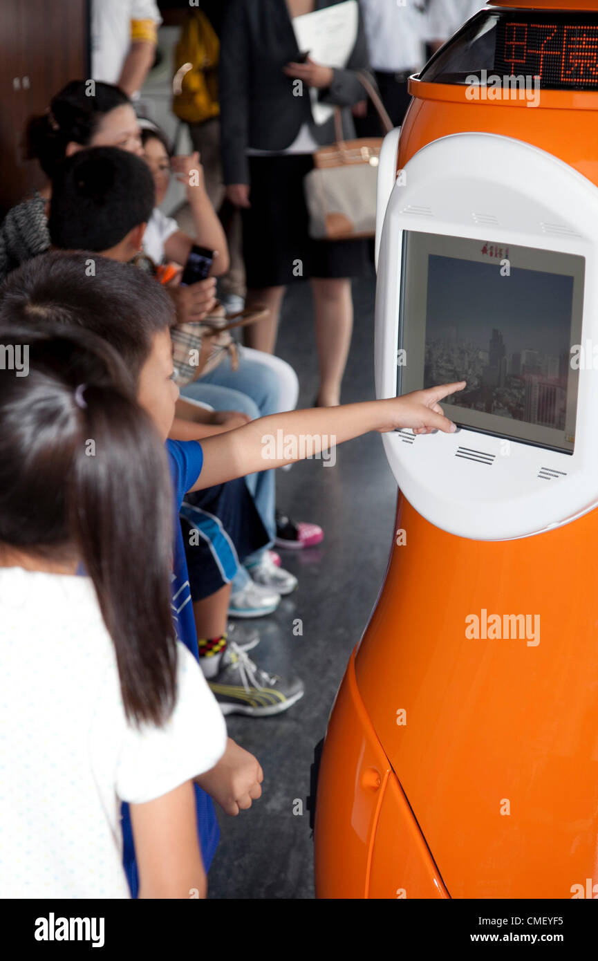 August 01 2012, Tokyo, Japan - A kid touches the new robot guide ...