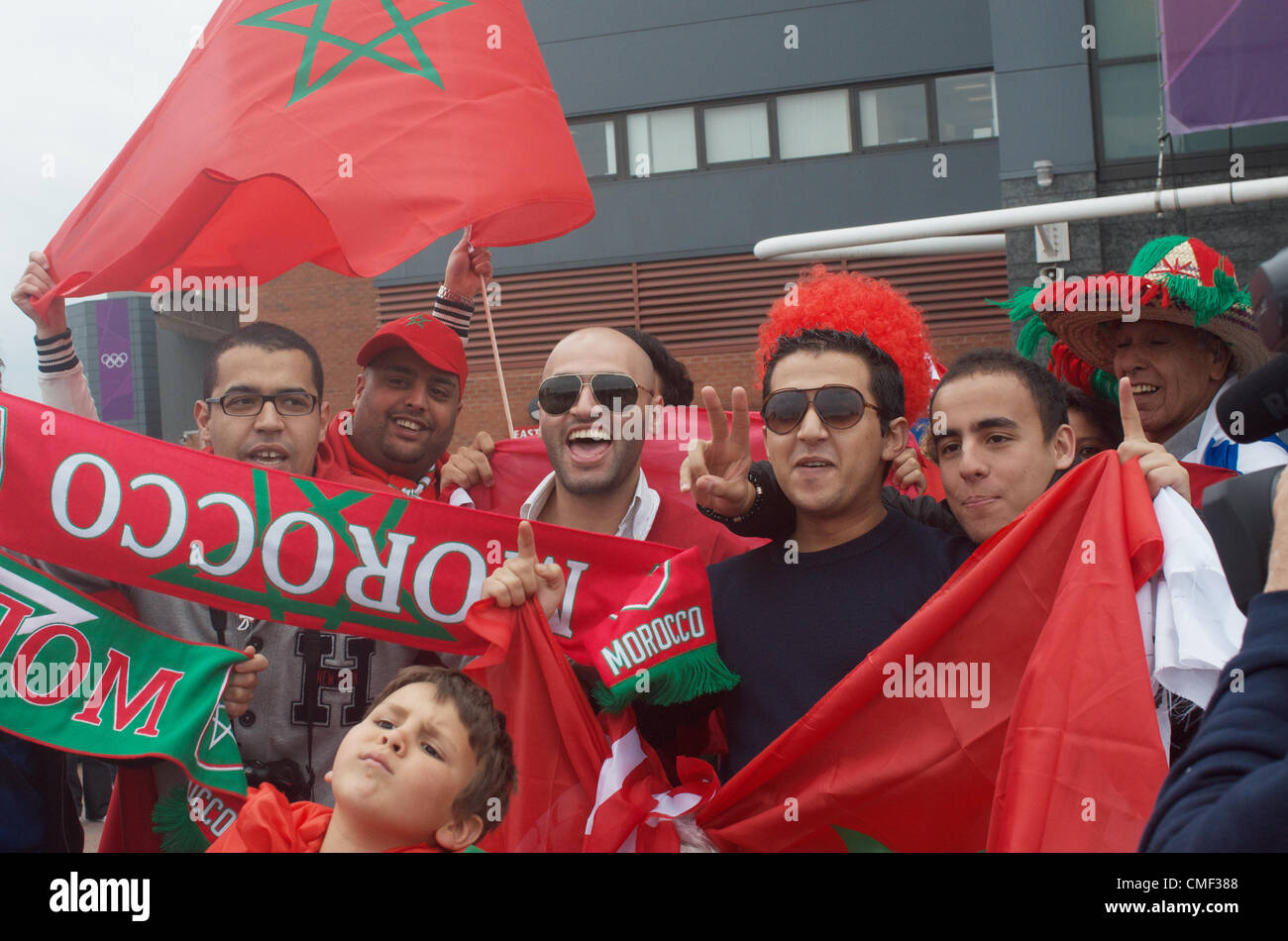 Manchester, UK. 1st August 2012. Moroccan fans pose with flags outside ...