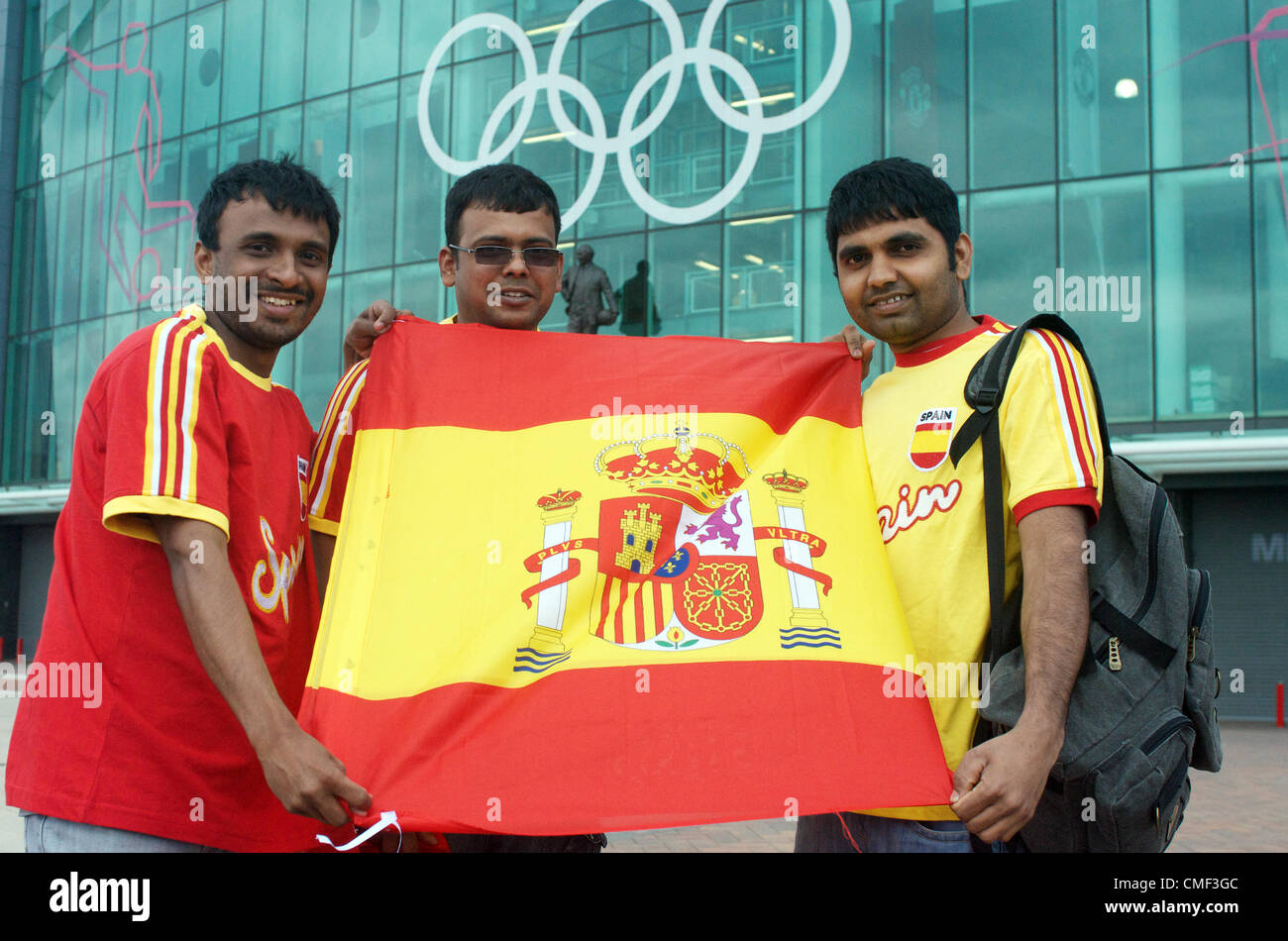 Three Spanish fans pose with the Spanish flag outside Old Trafford ...