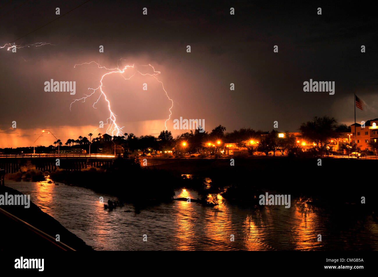 Lightning strikes during a monsoon downpour that fills the Rillito ...