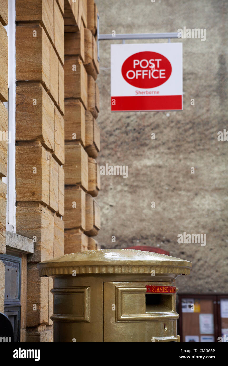 Sherborne, Dorset, UK Monday 6 August 2012. Royal mail gold painted ...