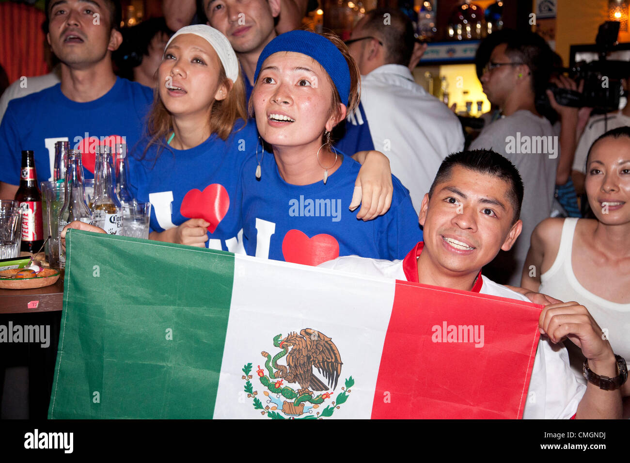 August 07 2012, Tokyo, Japan - Japanese and Mexican fans watch the ...