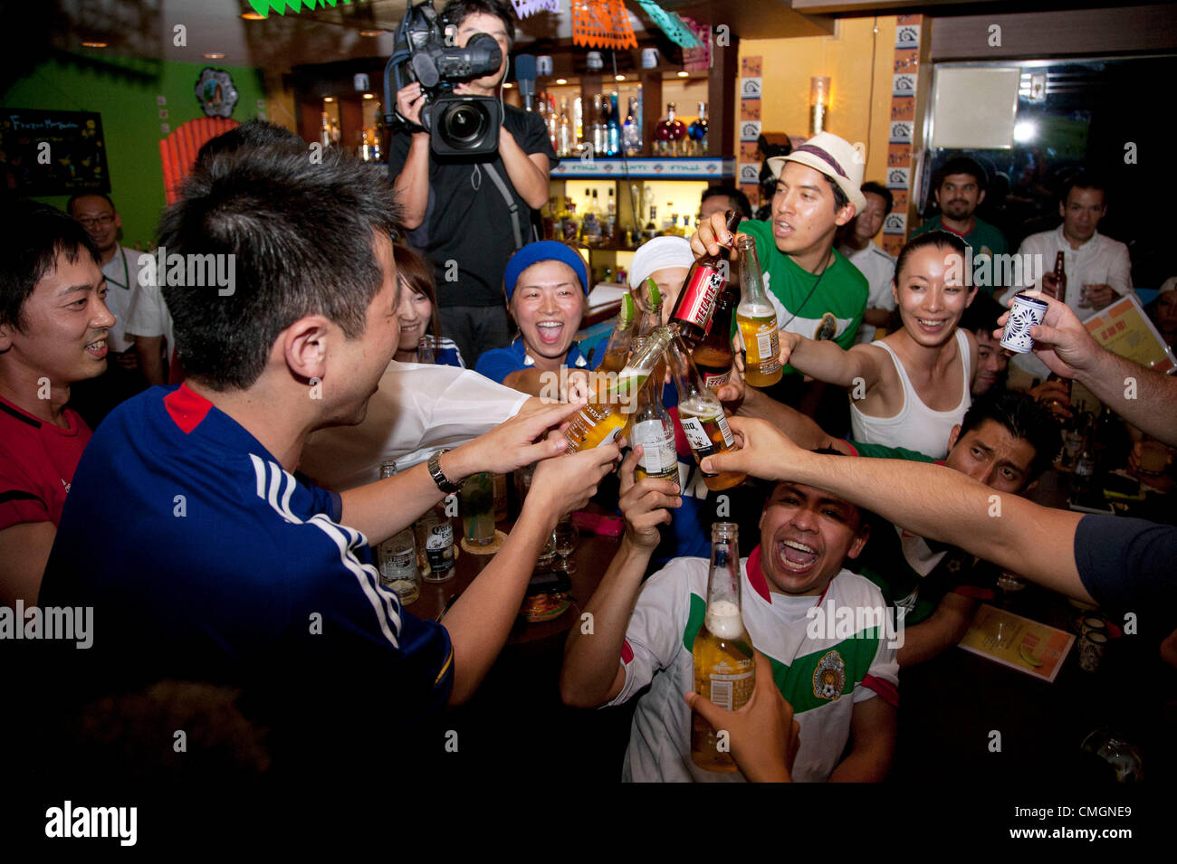 August 07 2012, Tokyo, Japan - Japanese and Mexican fans watch the ...