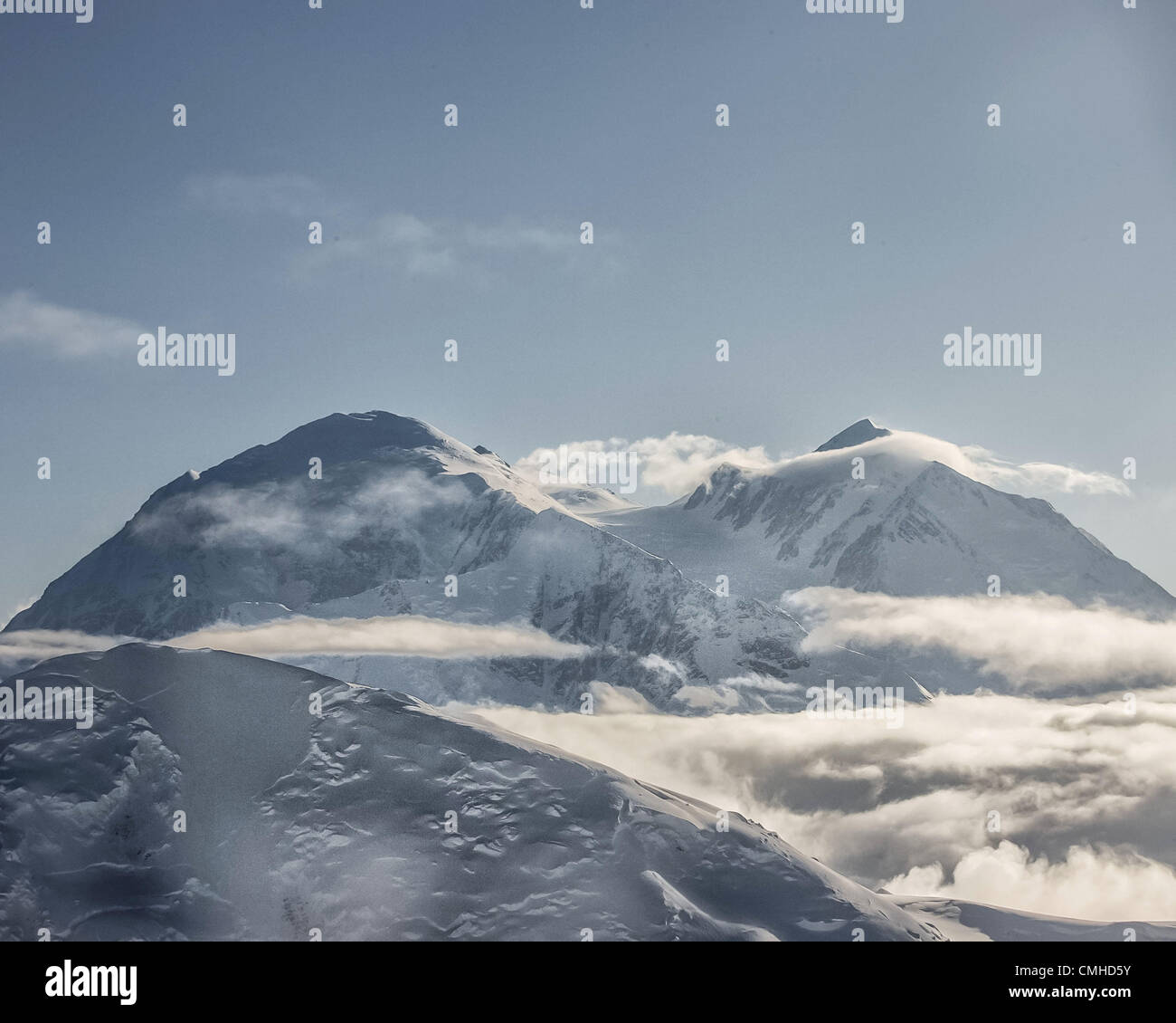 June 26, 2012 - Alaska, US - Layers of clouds dramatically bisect snow ...