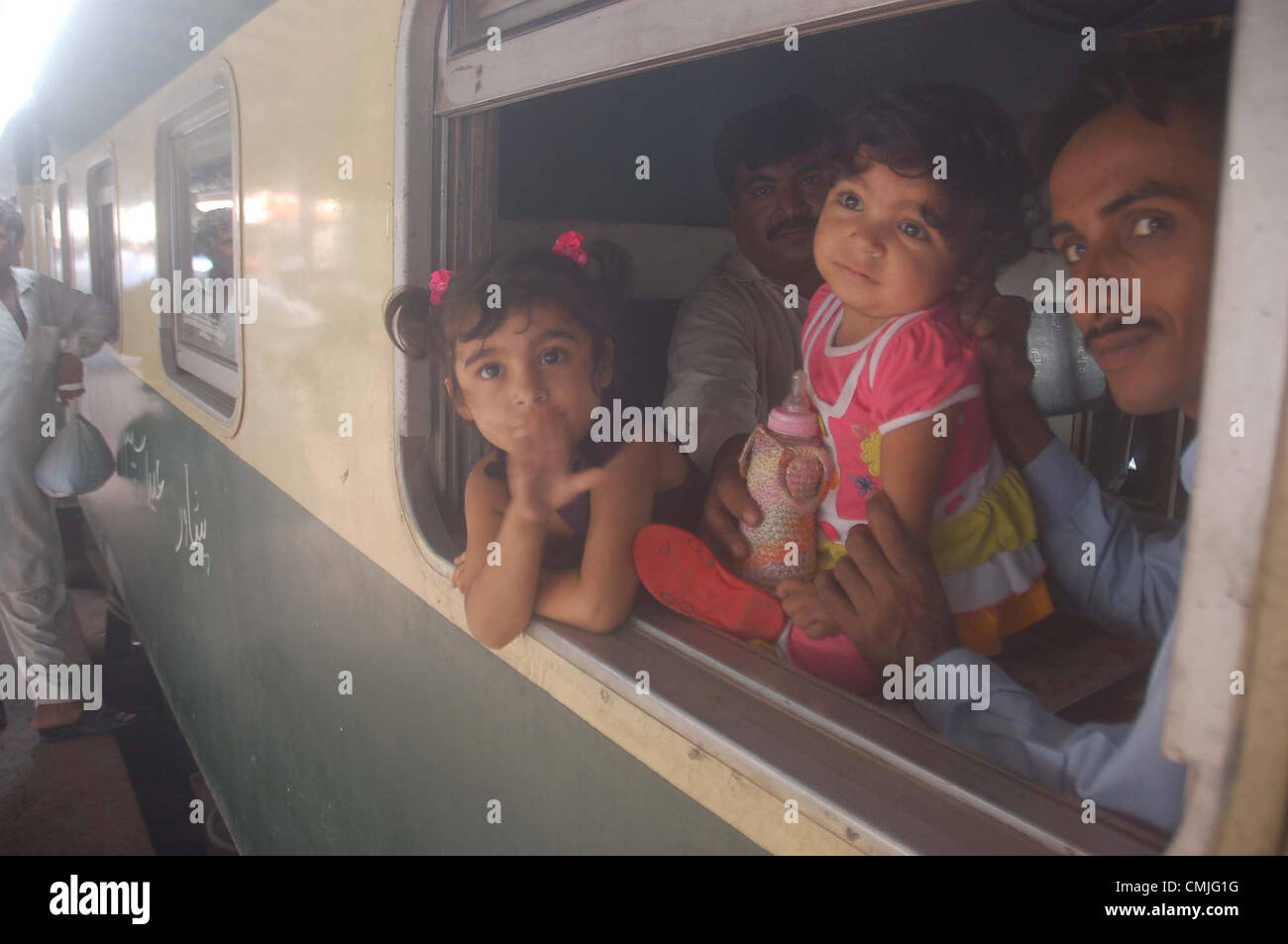 Passengers sit on Eid Special Train at Cantt Station as they wait to ...