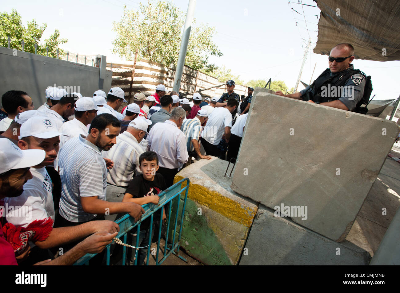 BETHLEHEM, WEST BANK - AUGUST 17, 2012: Palestinian men wait in line to ...