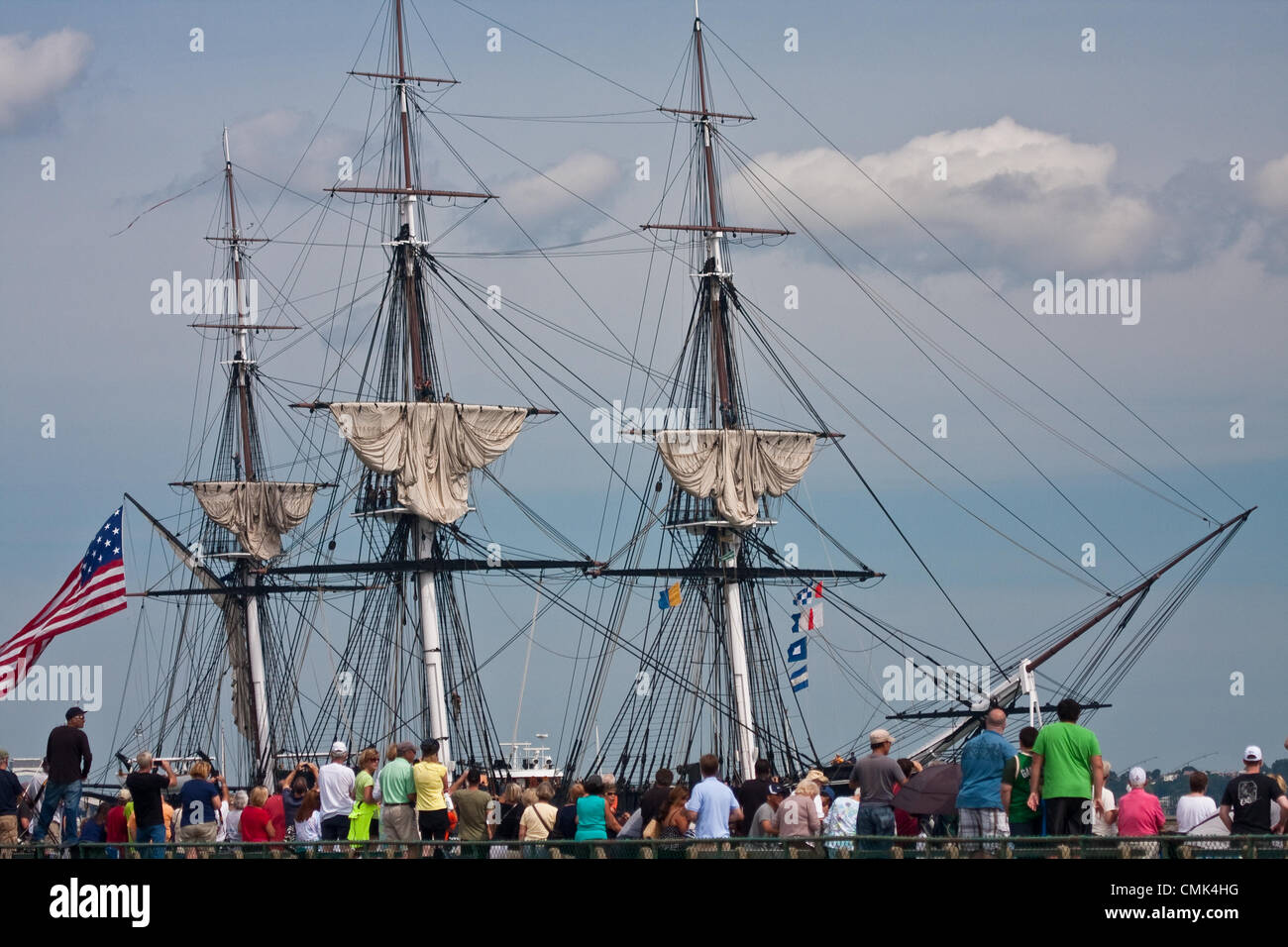 Spectators gather on Castle Island to watch the USS Constitution head ...