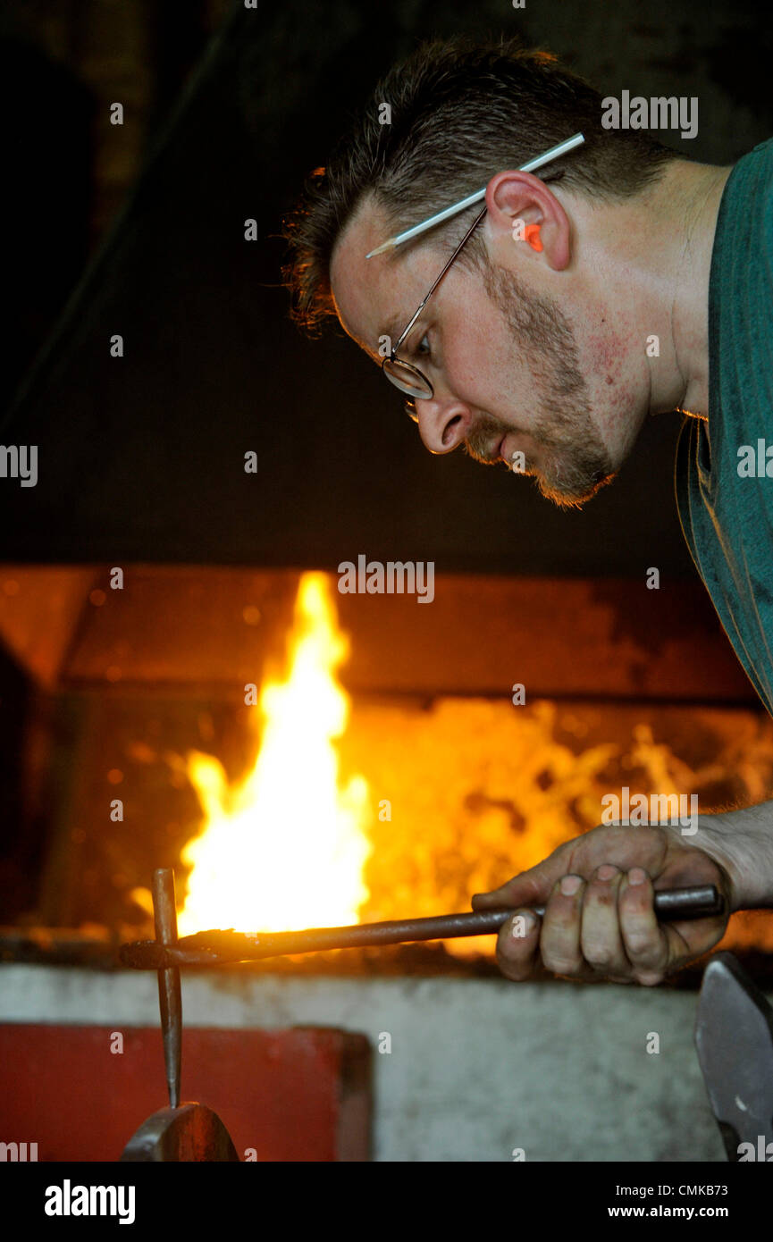 Three forgers from Pensylvania, USA work on big sundial during Forge ...
