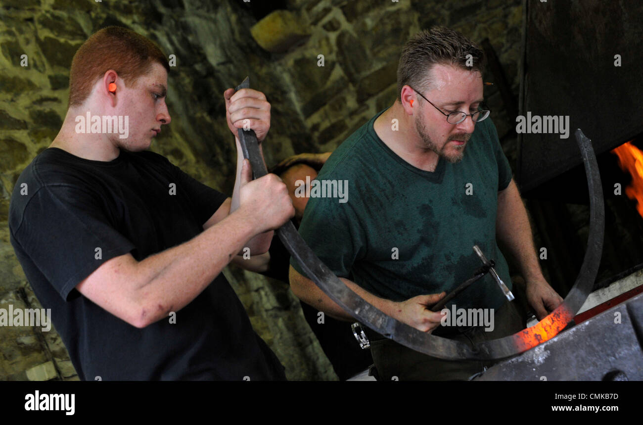 Three forgers from Pensylvania, USA work on big sundial during Forge ...