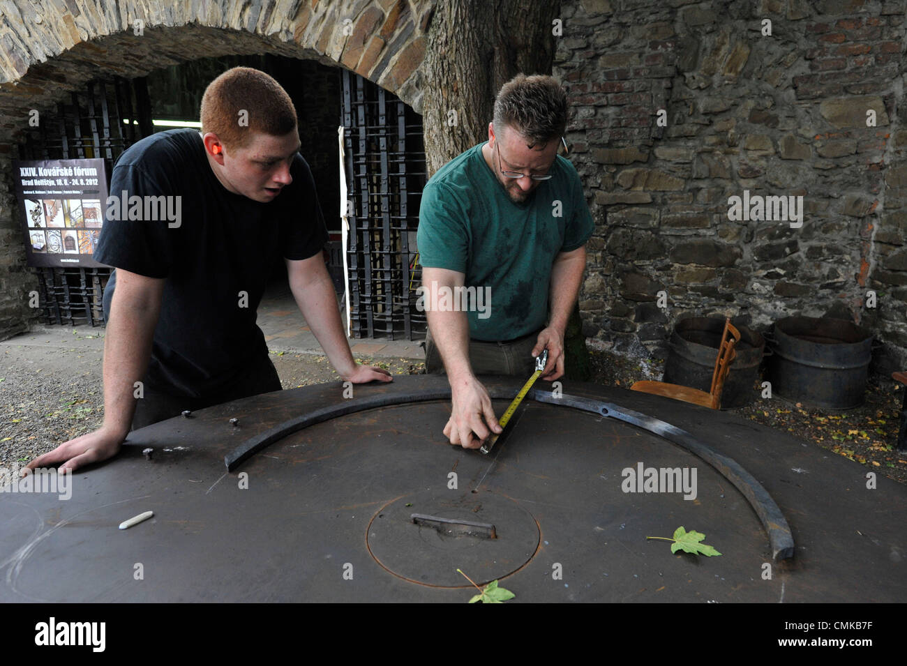Three forgers from Pensylvania, USA work on big sundial during Forge ...