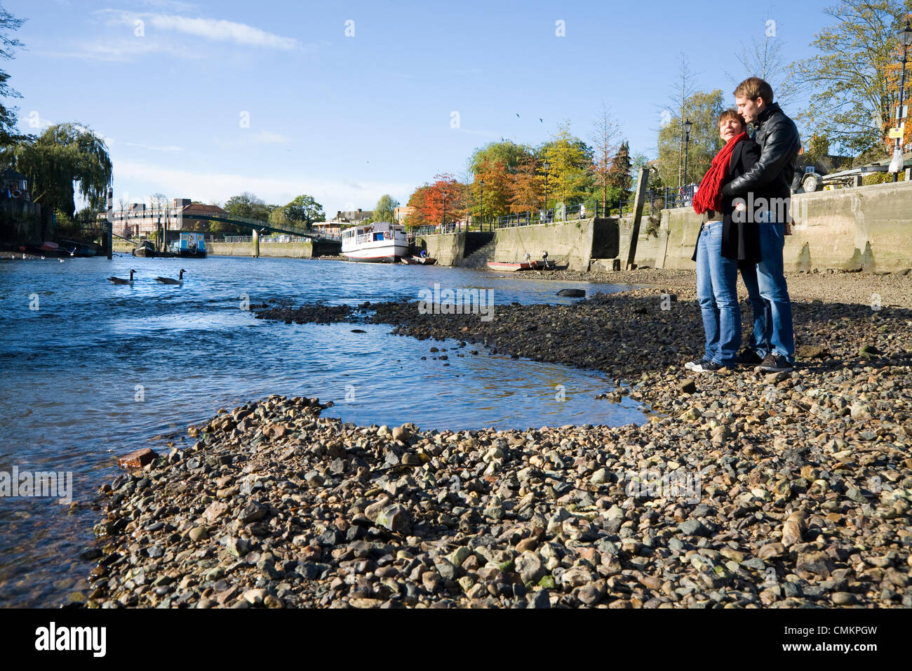 River Thames Twickenham riverside. Couple / people standing on the ...