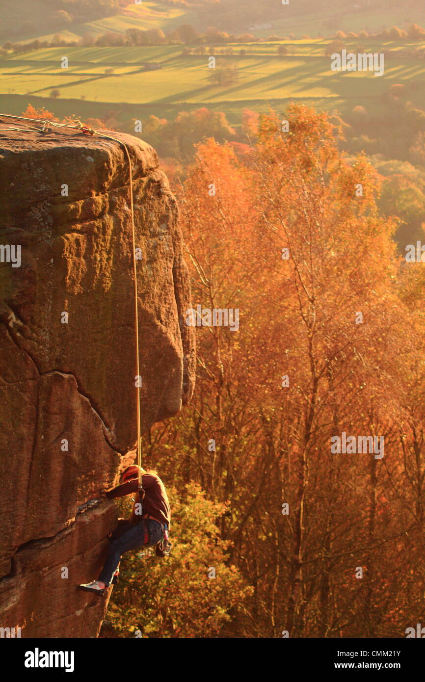 A rock climber tackles Froggatt Edge above the Derwent Valley on a fine ...