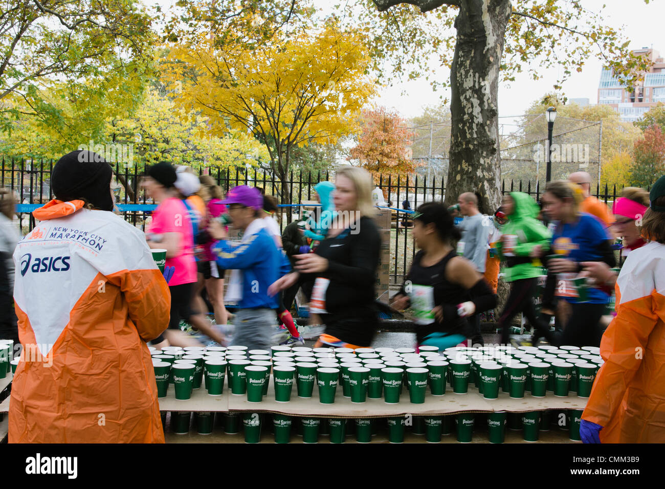 New York, USA. 03rd Nov, 2013. Volunteer handing out water to runners ...