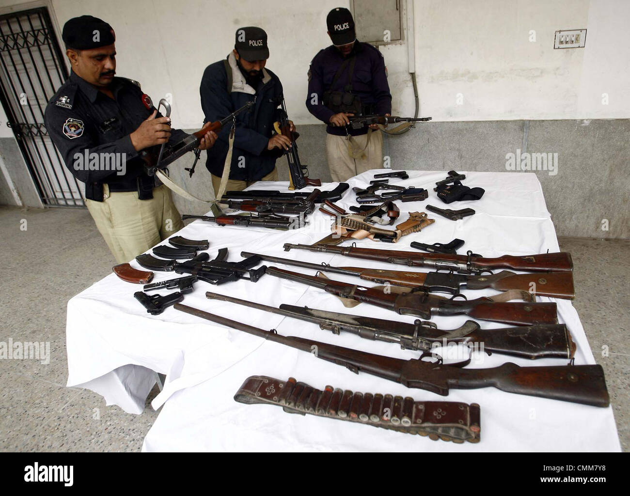 Police officials showing seized weapon recovered from arrested ...