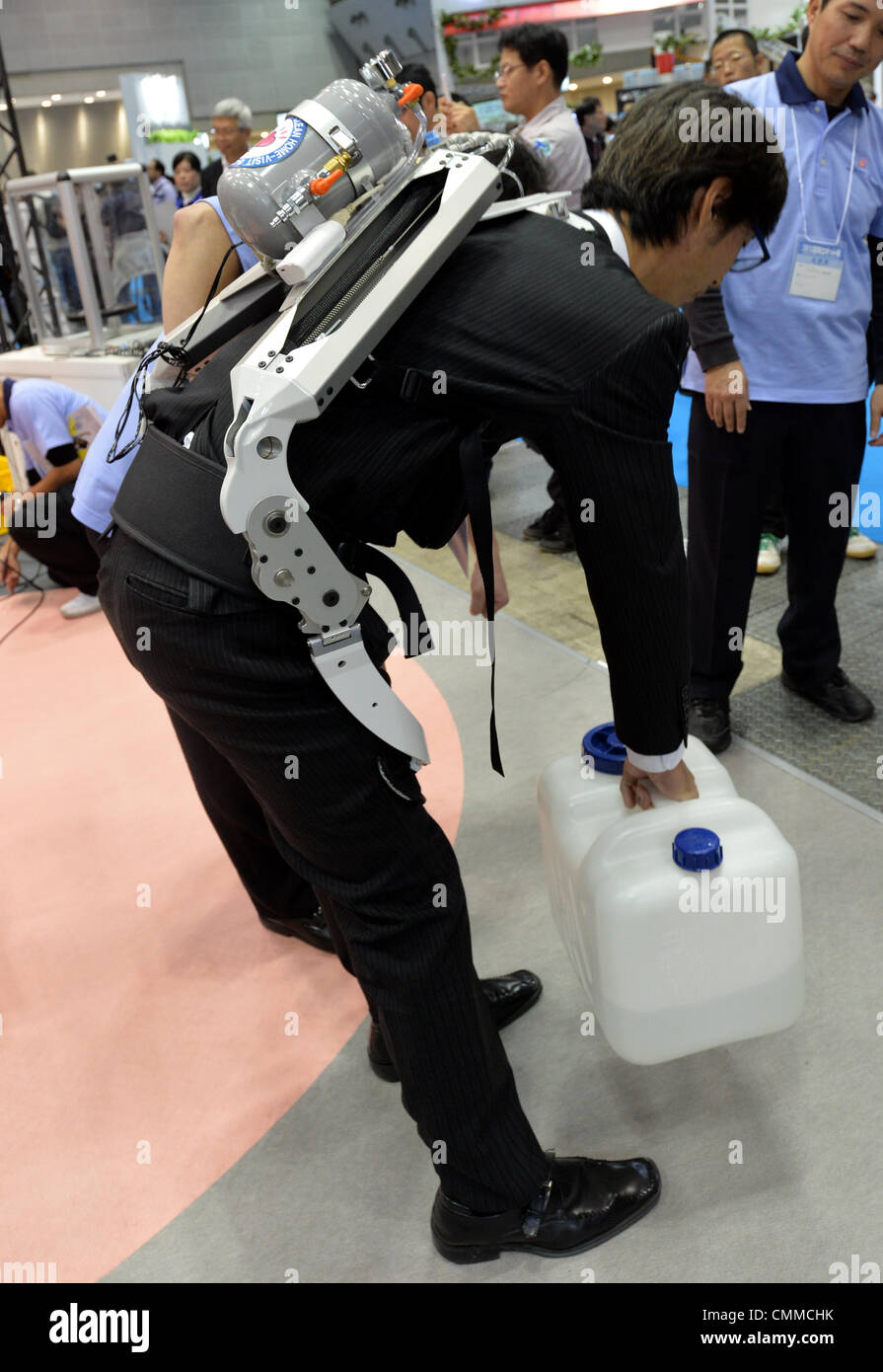 Tokyo, Japan. 6th Nov, 2013. An attendant lifts up a water-filled ...