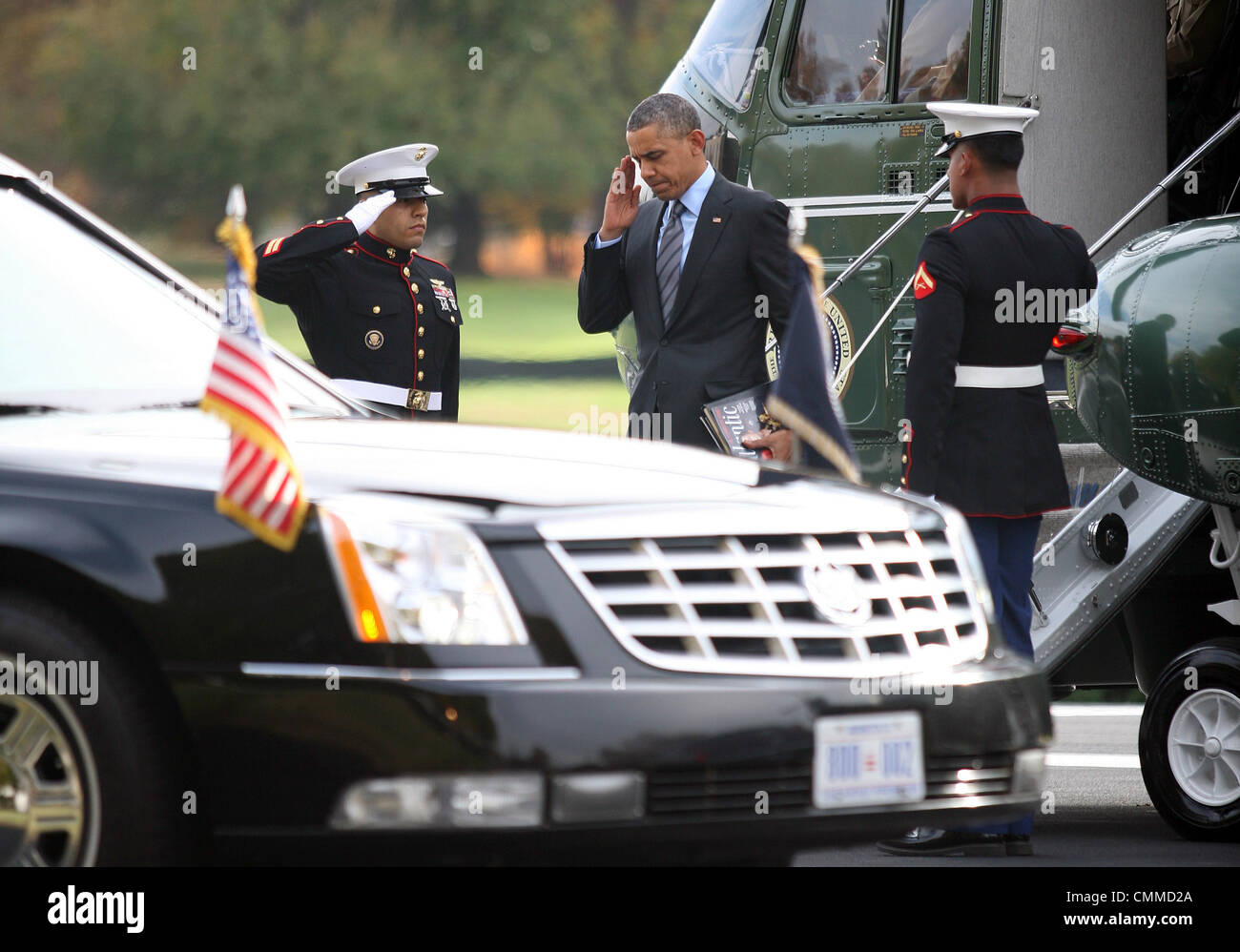 United States President Barack Obama salutes the Marine Guard as he ...