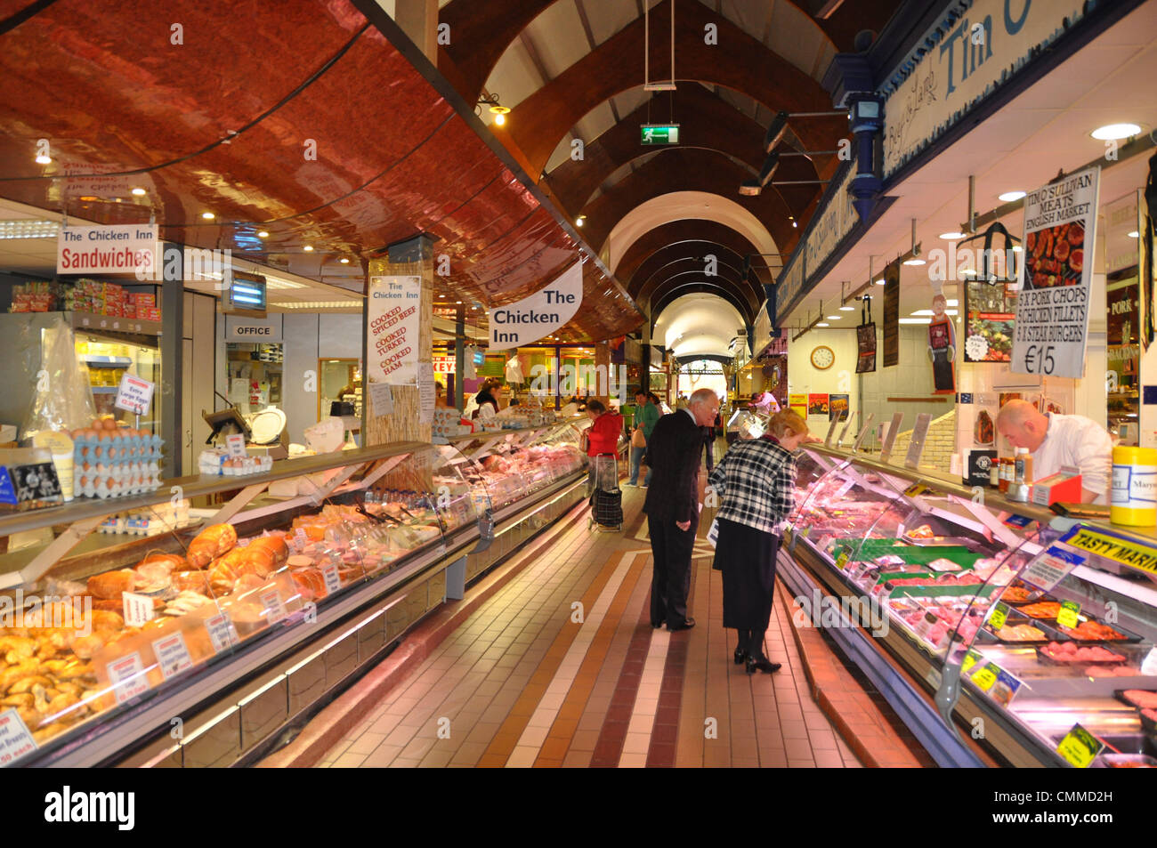 Visitors look at meat and poultry on sale in the English Market in Cork ...