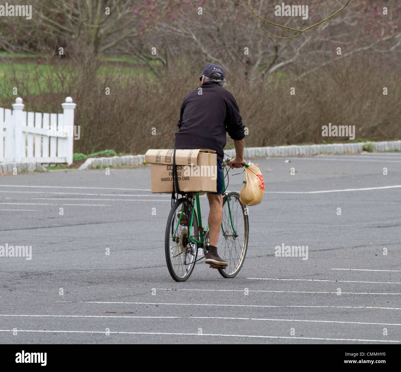 A homeless man on a bicycle with bags and box Stock Photo - Alamy