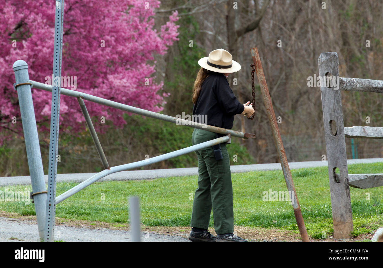 Park ranger locking a gate Stock Photo - Alamy