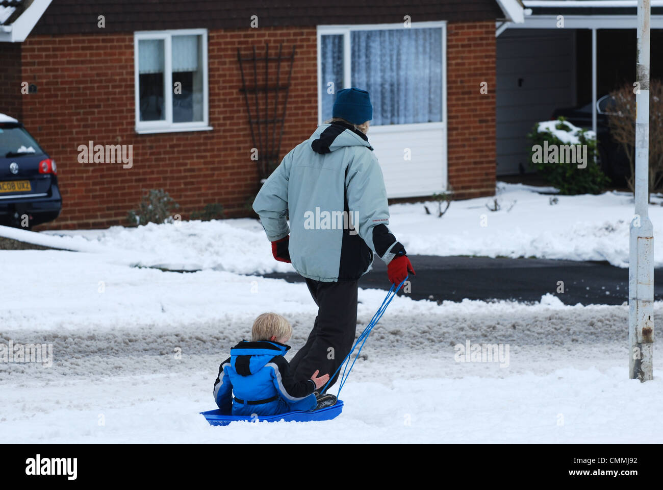 man with a sledge in the snow UK Stock Photo - Alamy