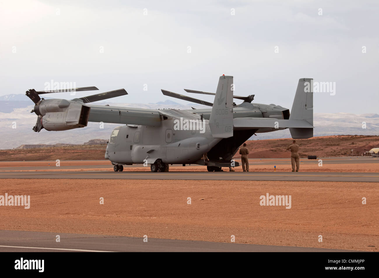 Aircraft V-22 Osprey VTOL rotor folded mode on ground with crew members ...