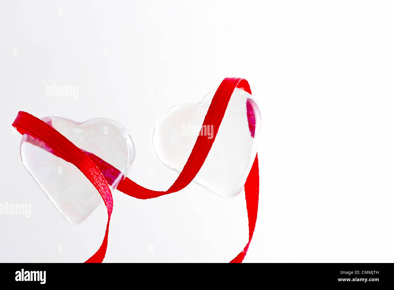 two crystal hearts with red ribbon isolated on white background Stock ...
