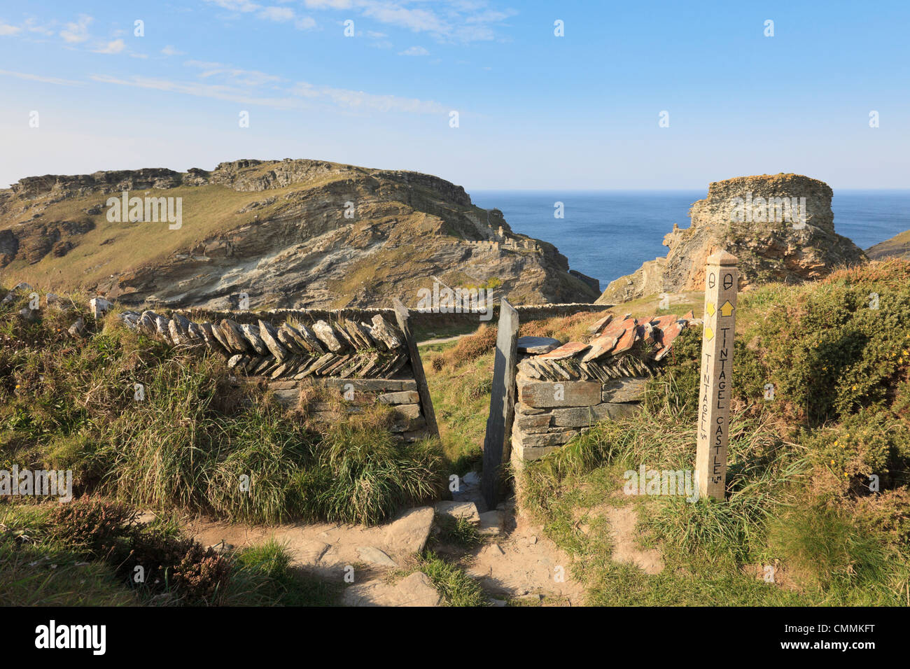 Path sign to King Arthur's Camelot Castle and stile through stone wall ...
