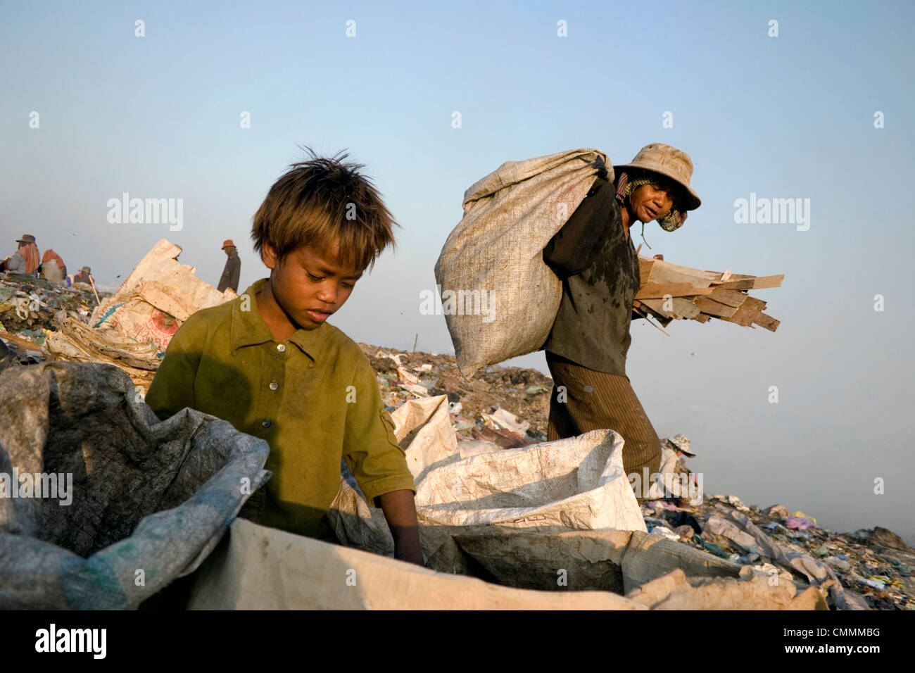 Workers, including child laborers, are collecting recyclable material ...