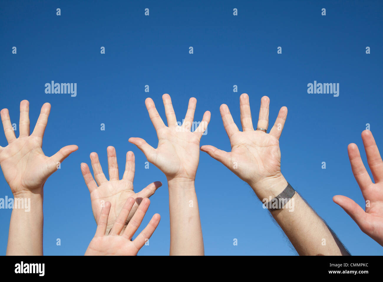Hands held in the air Stock Photo - Alamy