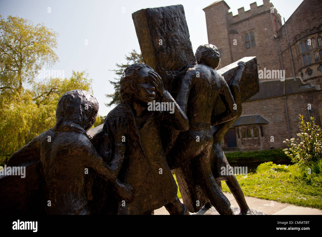 bronze statue depicting four people carrying a cross, religious ...