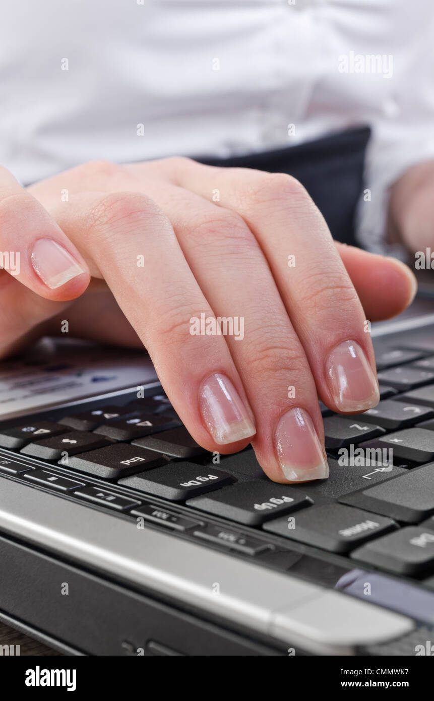 woman pressing enter key on the laptop computer keyboard, selective ...