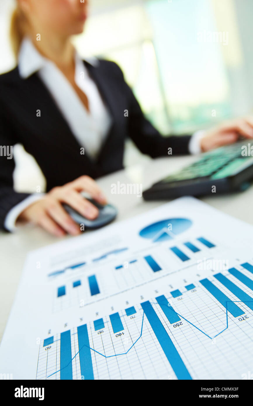 Image of business paper on background of female hands pushing keys of a ...