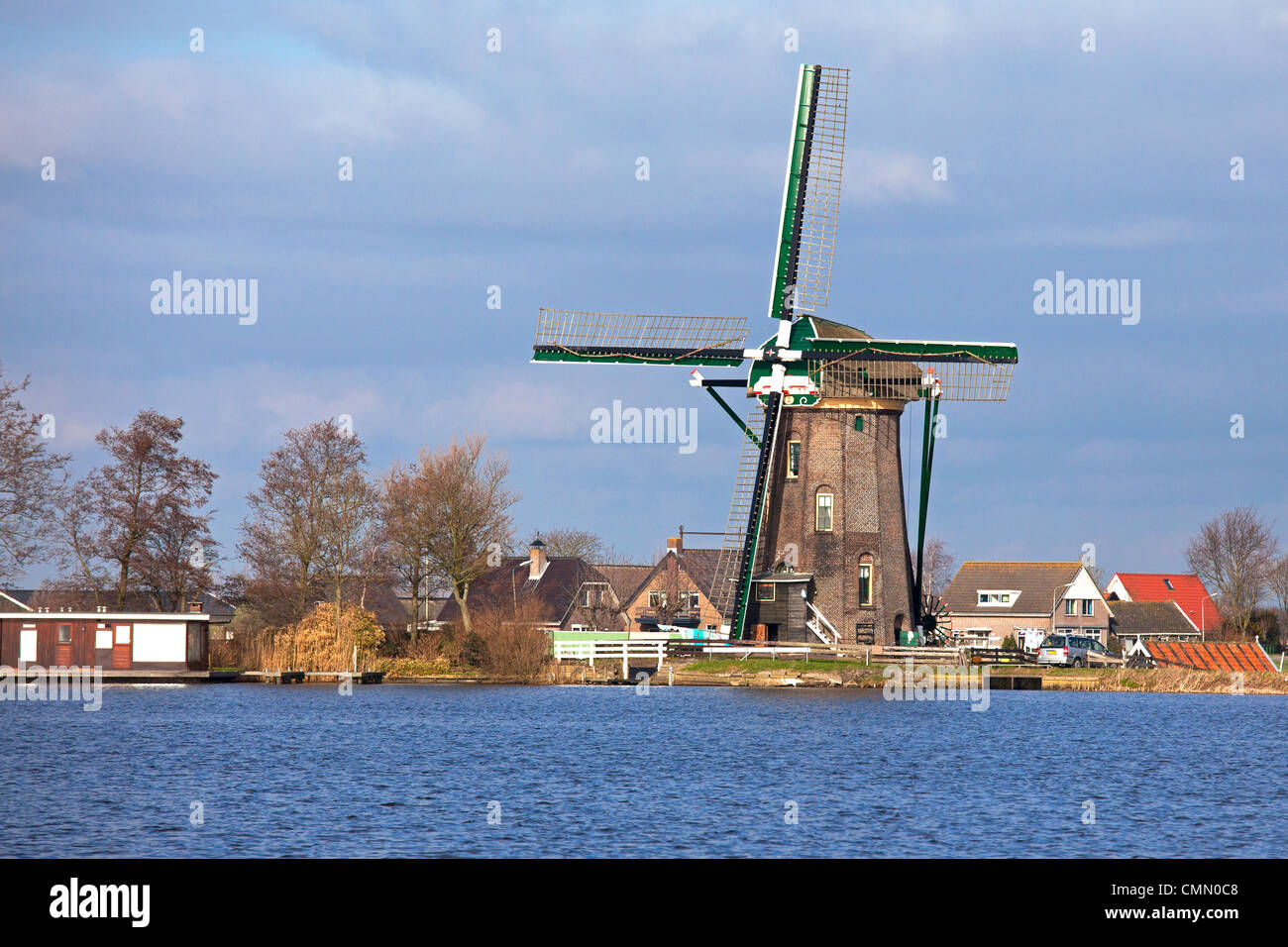 Stone Windmill in Dutch landscape Stock Photo - Alamy