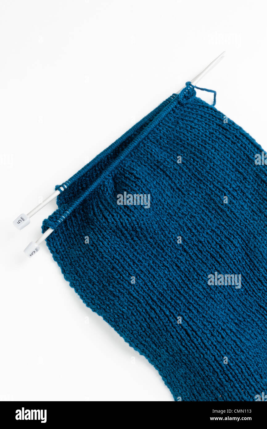 Blue wool on two knitting needles Stock Photo - Alamy
