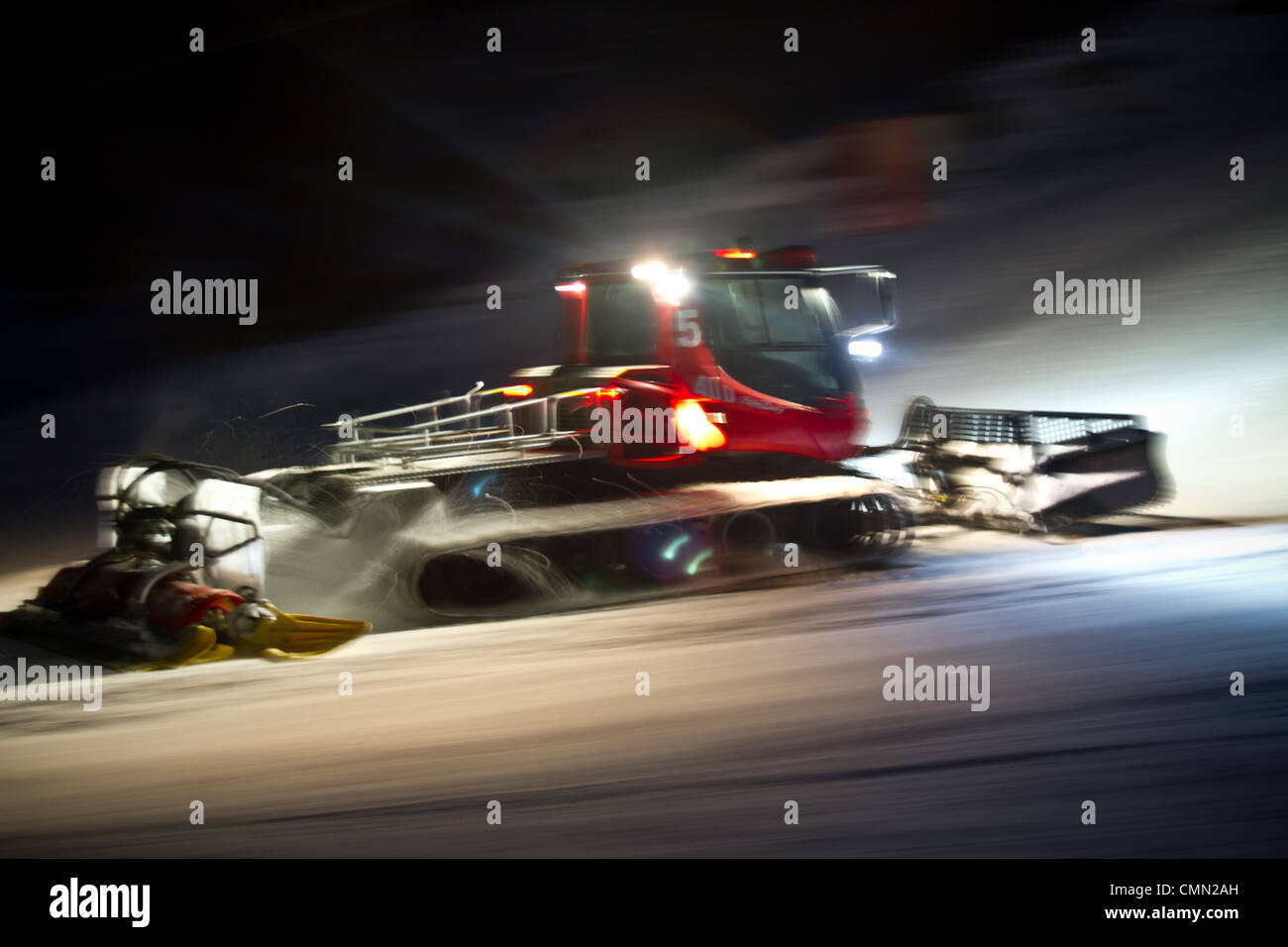 Snowcat machine at ski slope in the night Stock Photo - Alamy
