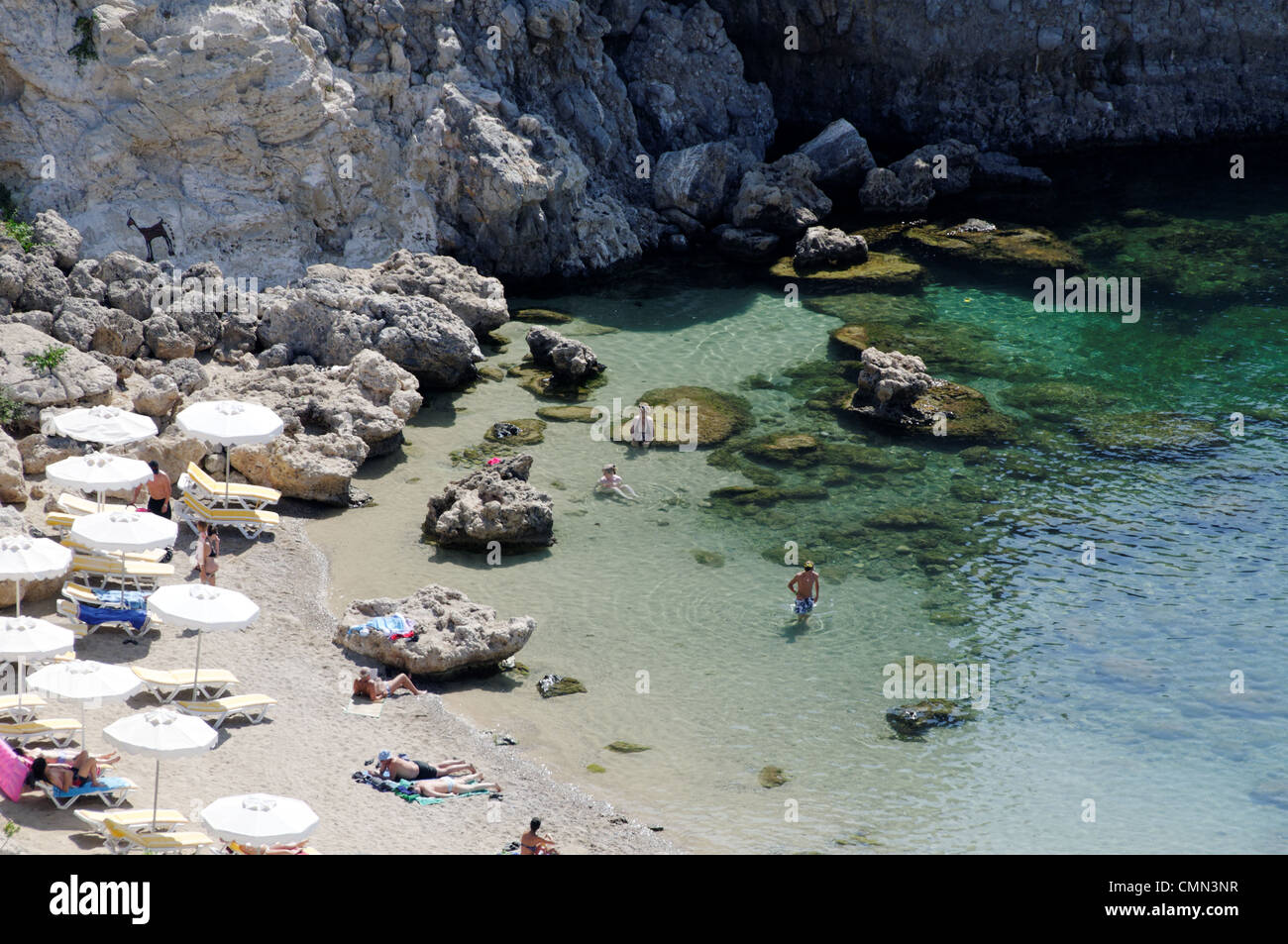 Rhodes. Greece. Tourists and locals bathing and sunbaking in St Paul’s ...