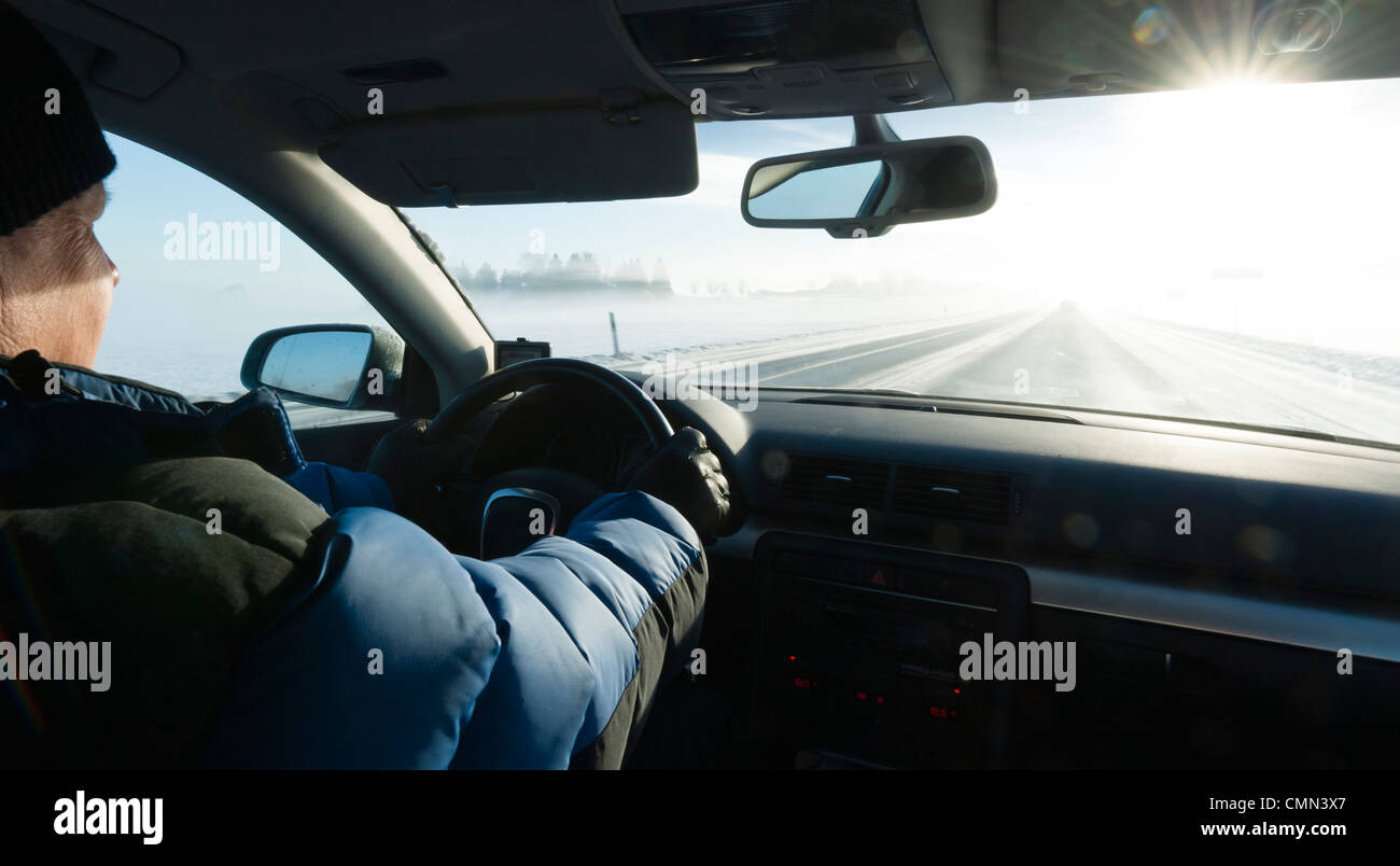 Man driving car, sun shining through the windshield Stock Photo - Alamy