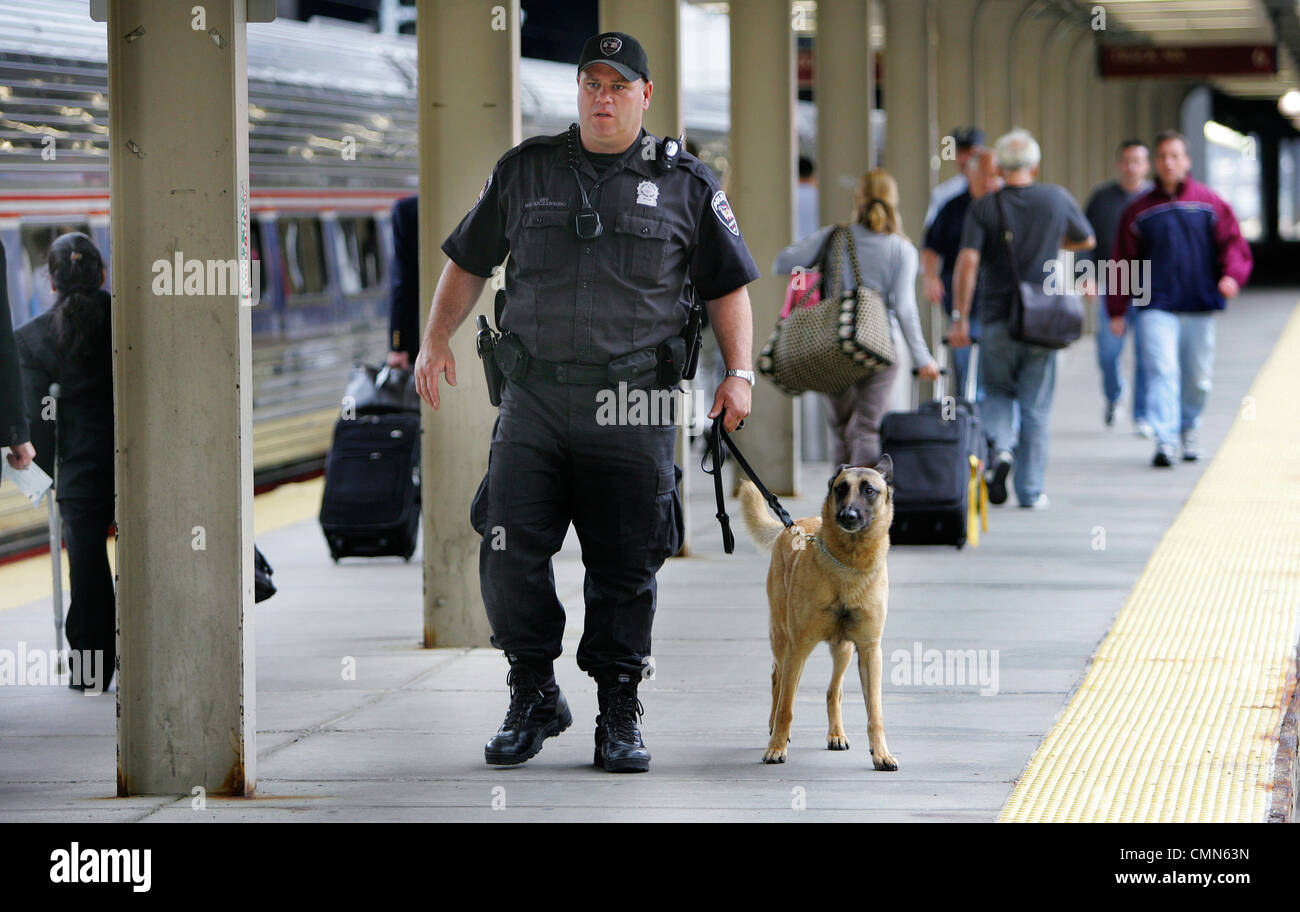 A police officer and bomb sniffing dog on patrol in South Station in ...