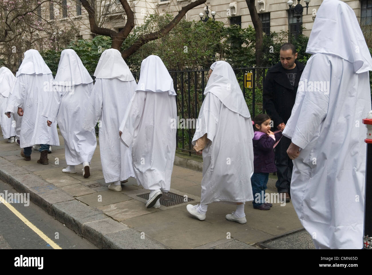 Asian child with father surprised at group of Druids going to disrobe ...