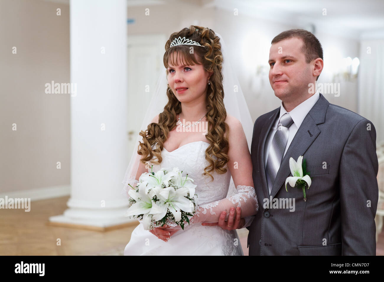 Young wedding Caucasian Russian couple. Bride standing near groom at ...