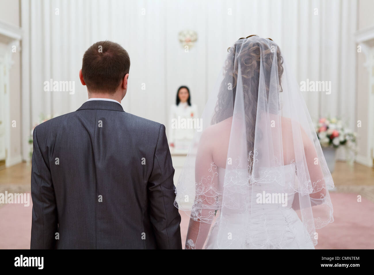 Young wedding Caucasian Russian couple. Bride standing near groom at ...