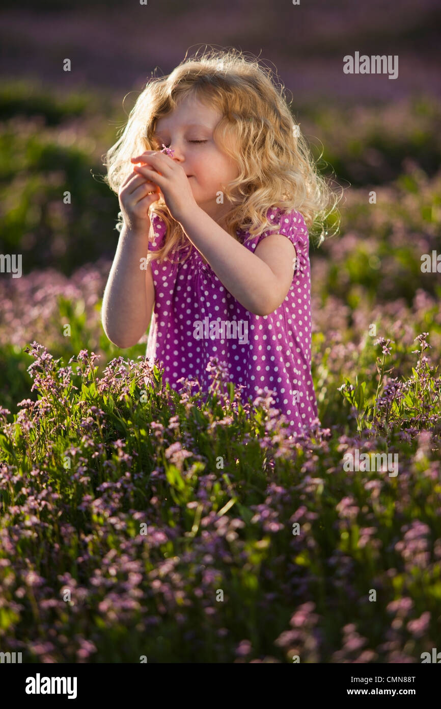Caucasian girl smelling flowers Stock Photo - Alamy
