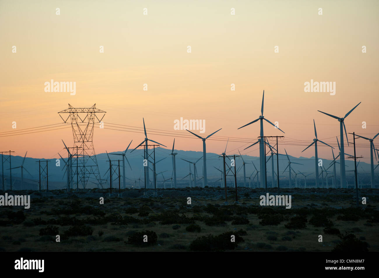 Wind farm in desert at sunset Stock Photo - Alamy