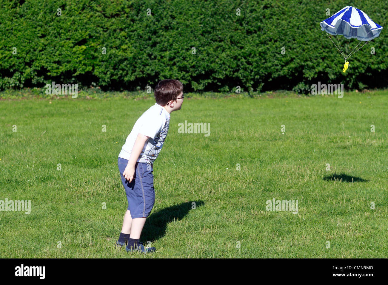 ten year old boy playing with his parachute toy in the park Stock Photo ...