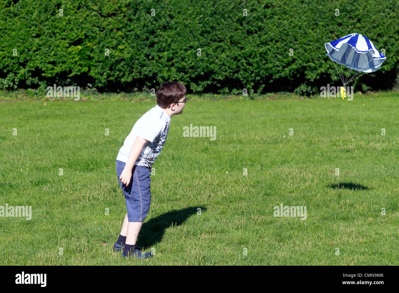 ten year old boy playing with his parachute toy in the park Stock Photo ...
